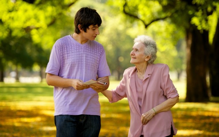 A young man helping an elderly woman | Faith.ph A young man helping an elderly woman | Faith.ph